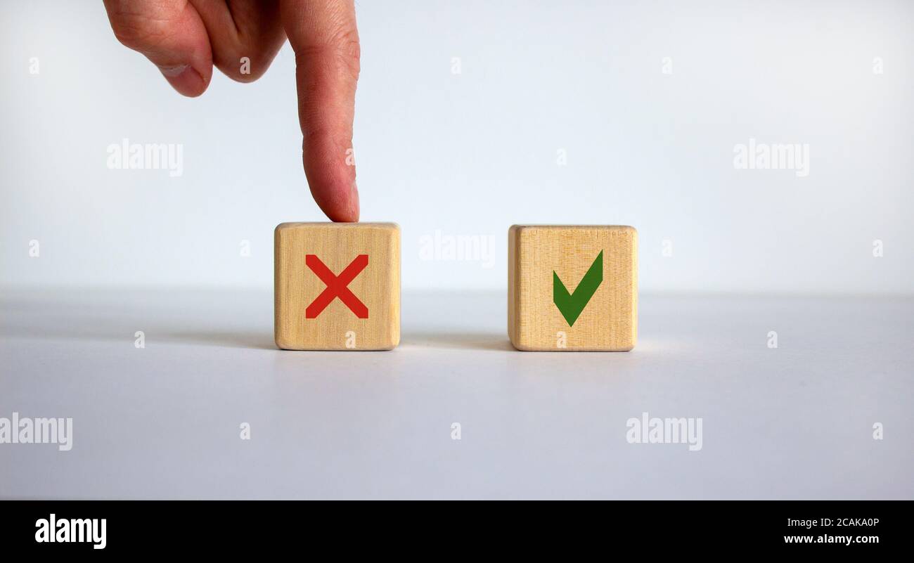 Hand making a choice between two cubes with No and Yes signs on neutral ...