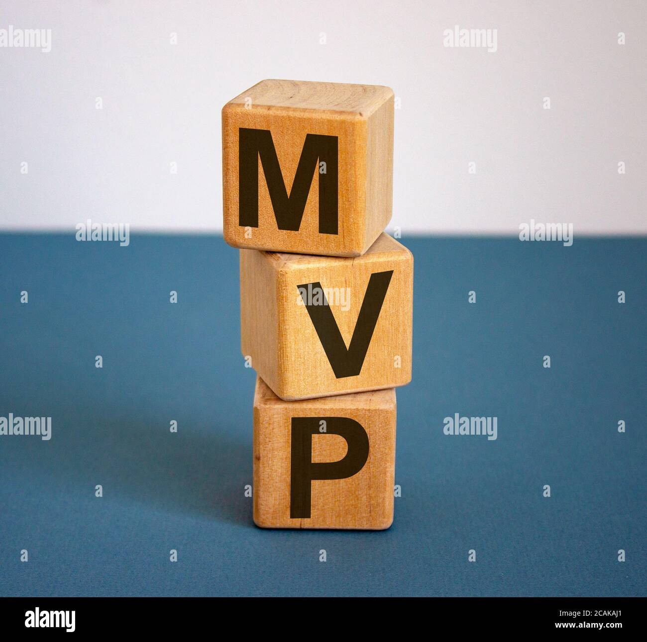 Concept word 'MVP' on cubes on a beautiful blue background. Business ...