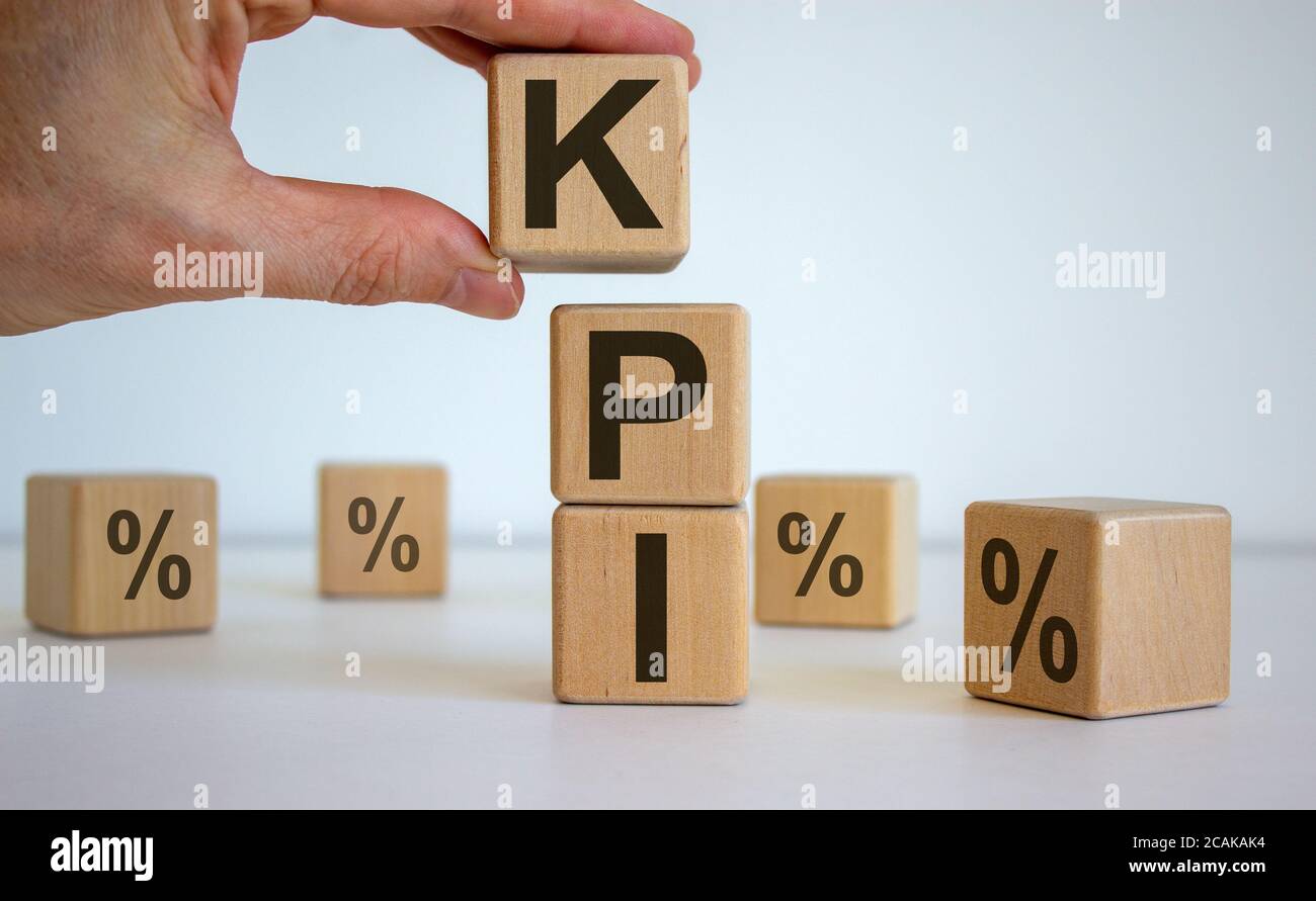 Male hand placing a cube with letter K on top of a other cubes. KPI ...