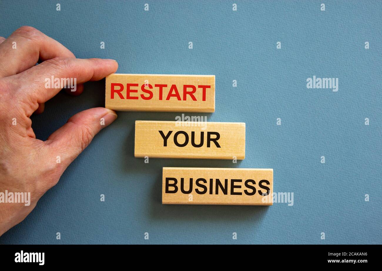 Wooden blocks form the words 'restart your business' on blue background ...