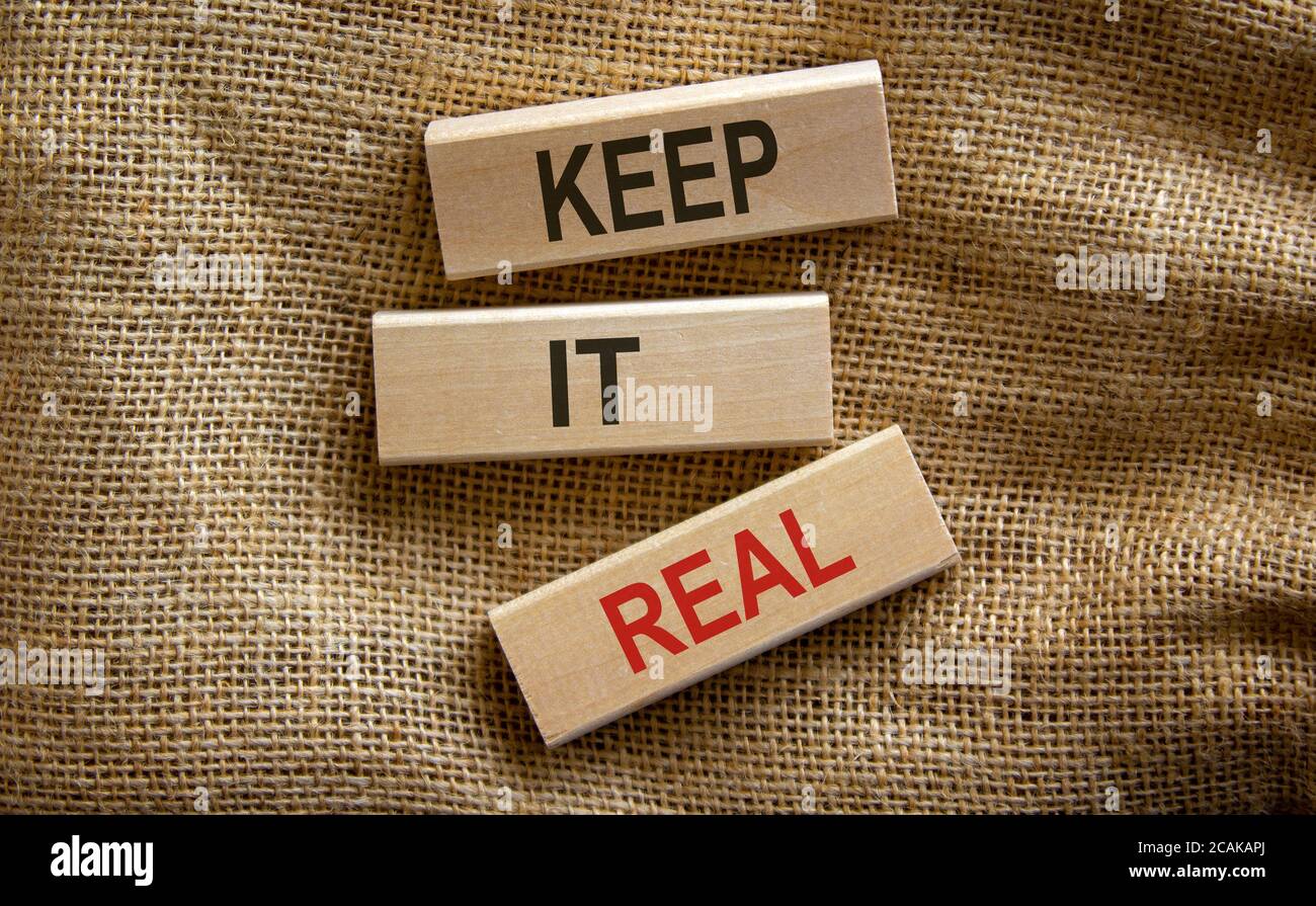 Wooden blocks form the text 'keep it real' on beautiful canvas ...