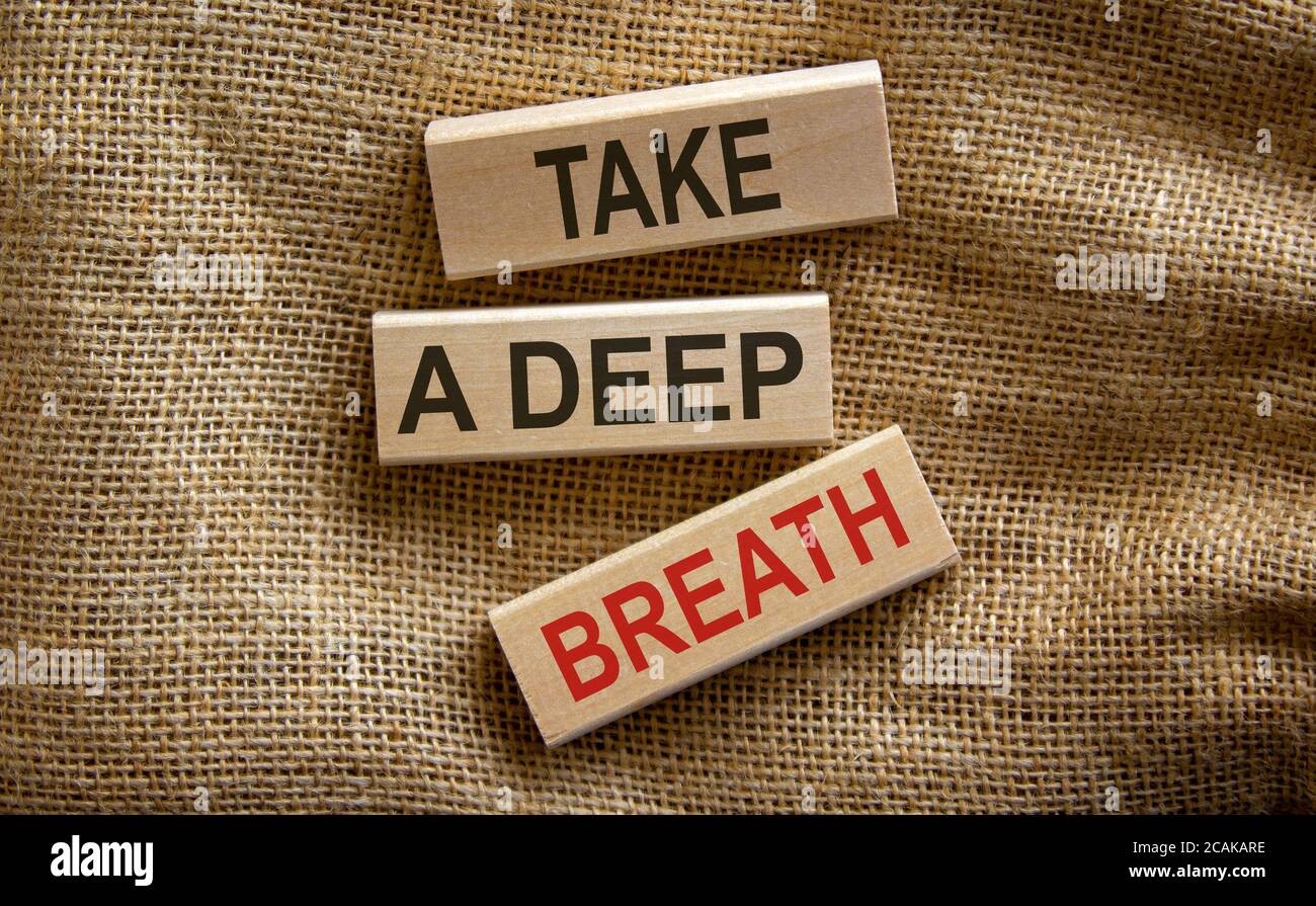 Wooden blocks form the text 'take a deep breath' on beautiful canvas ...