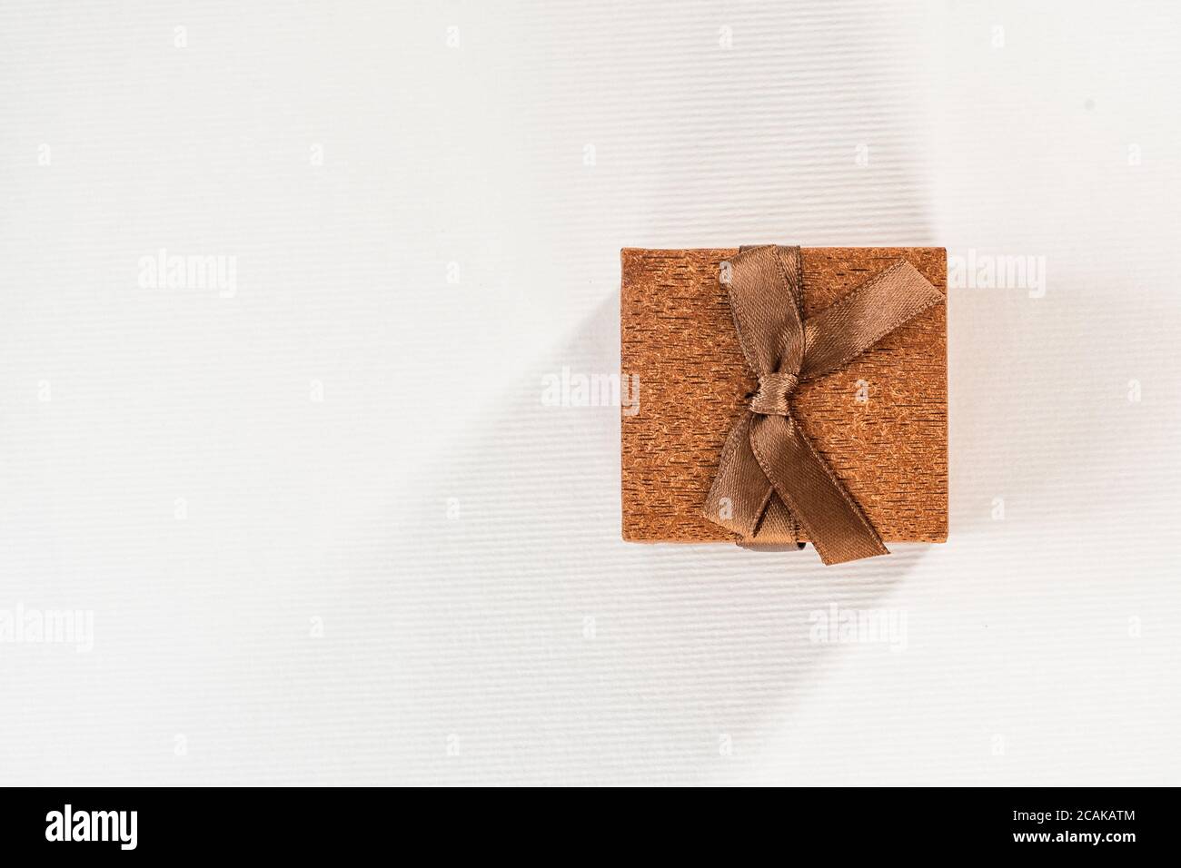 Brown closed jewelry box. Present. White background Stock Photo - Alamy