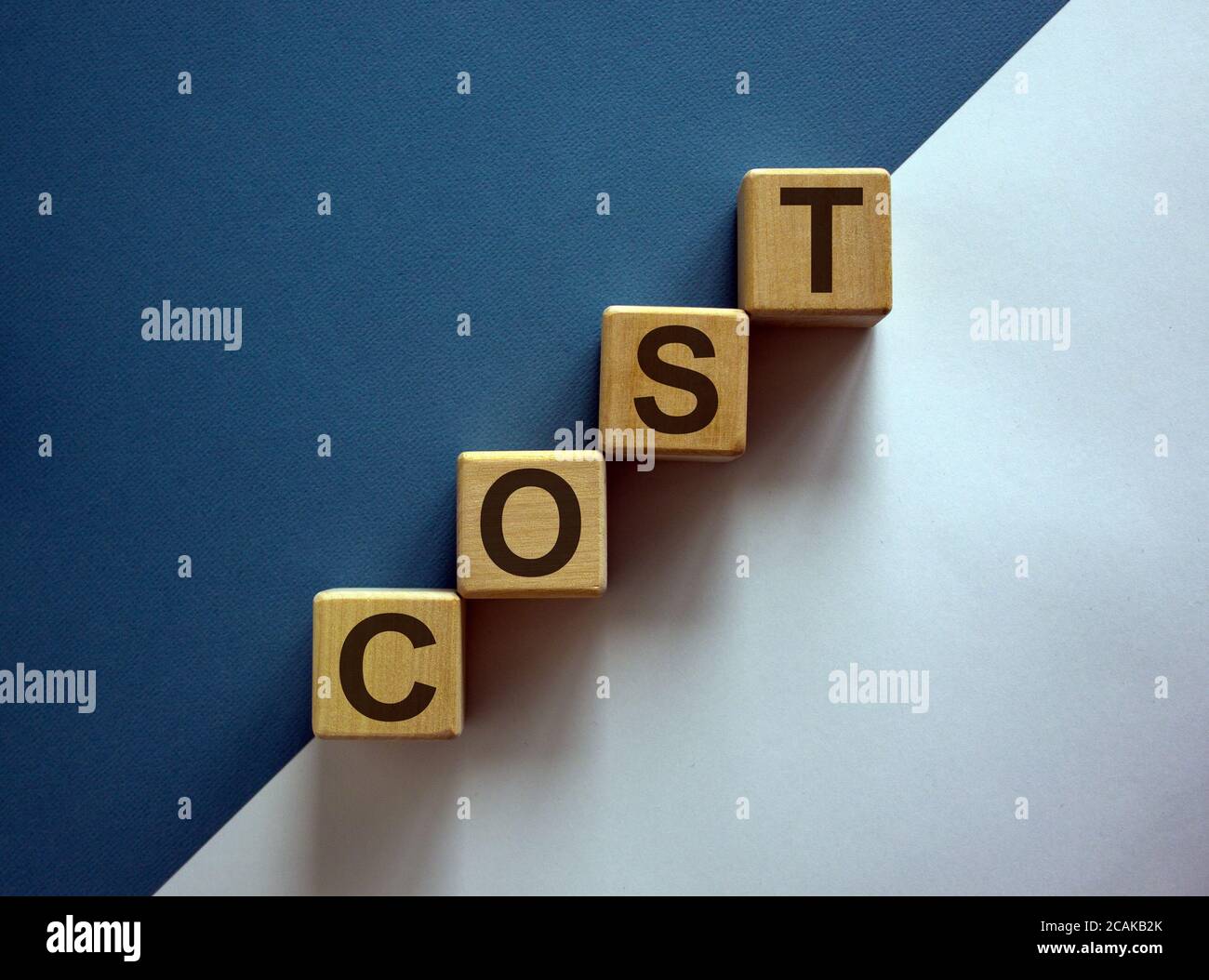 Wood block with word 'cost' stacking as step stair on paper blue and ...