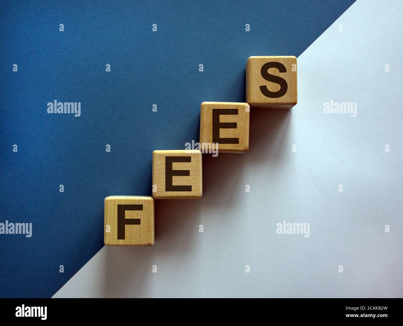 Concept word 'fees' on cubes on a beautiful white and blue background ...