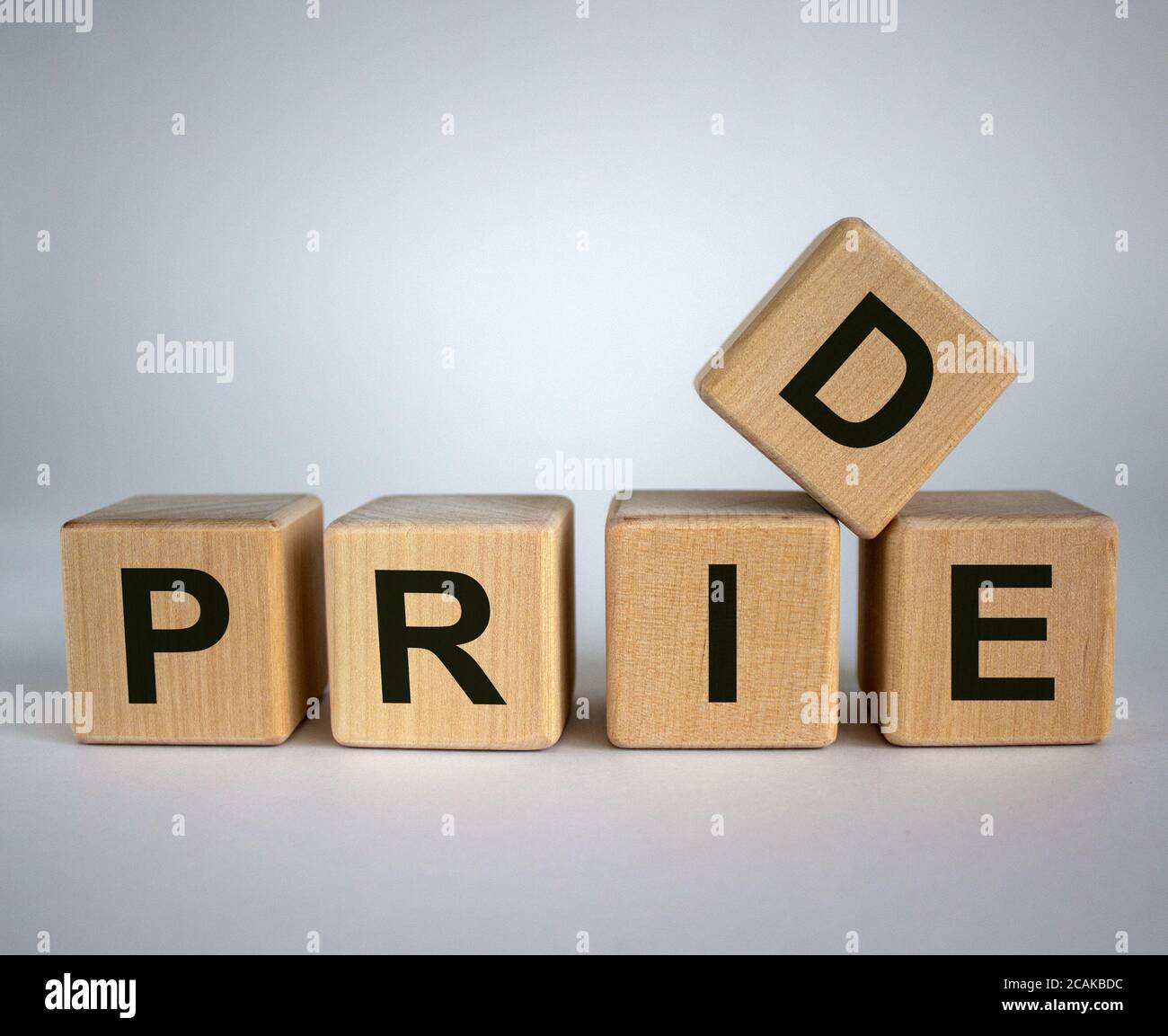 Wooden cubes with word 'pride'. Concept image Stock Photo - Alamy