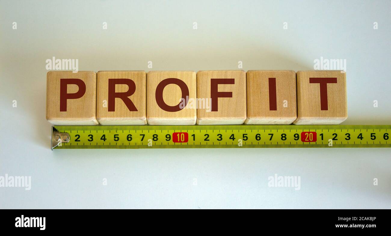'Profit' word on cubes arranged behind the ruler on beautiful white ...
