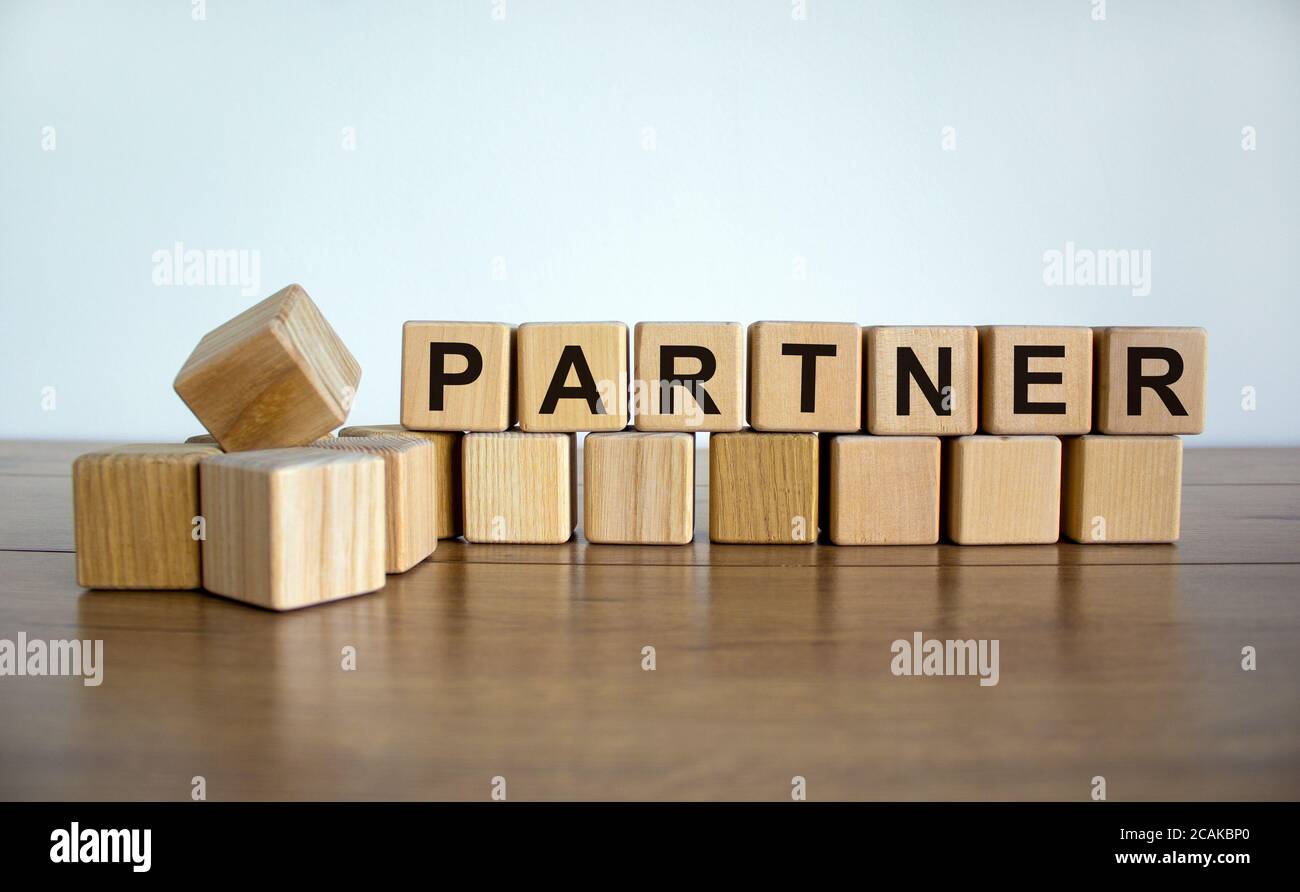 Concept word 'partner' on wooden cubes on a beautiful wooden table ...