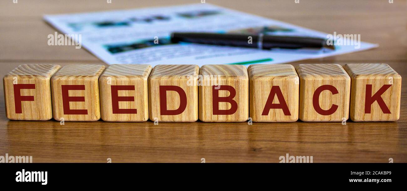 Concept word 'feedback' on cubes on a beautiful wooden table, pen and ...