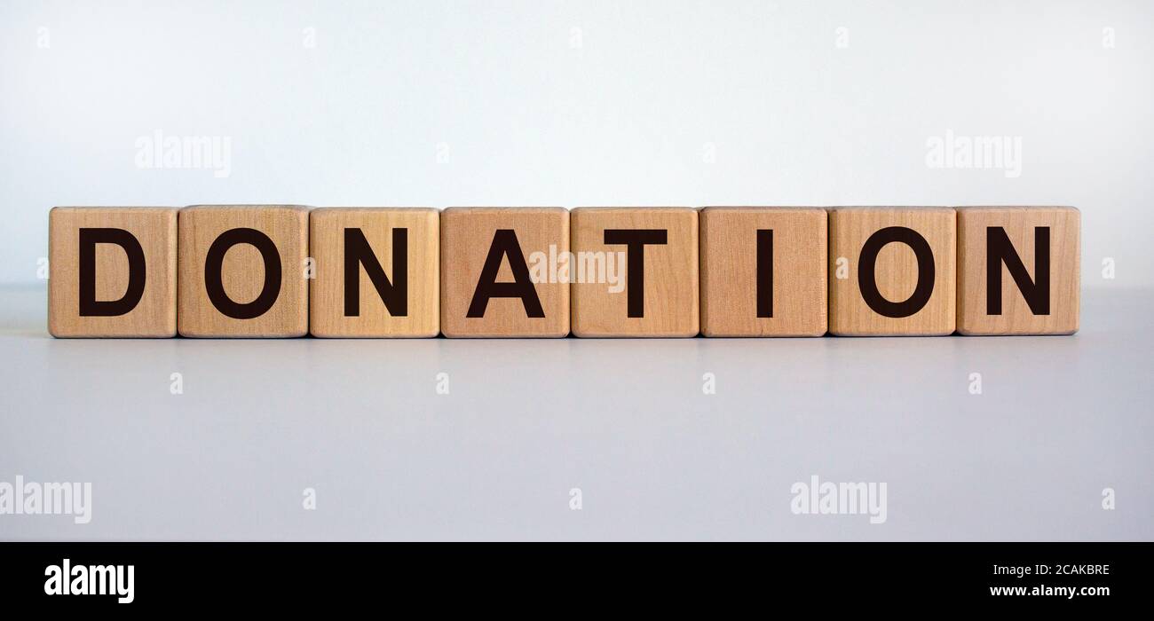 Concept word 'donation' on wooden cubes on a beautiful white background ...