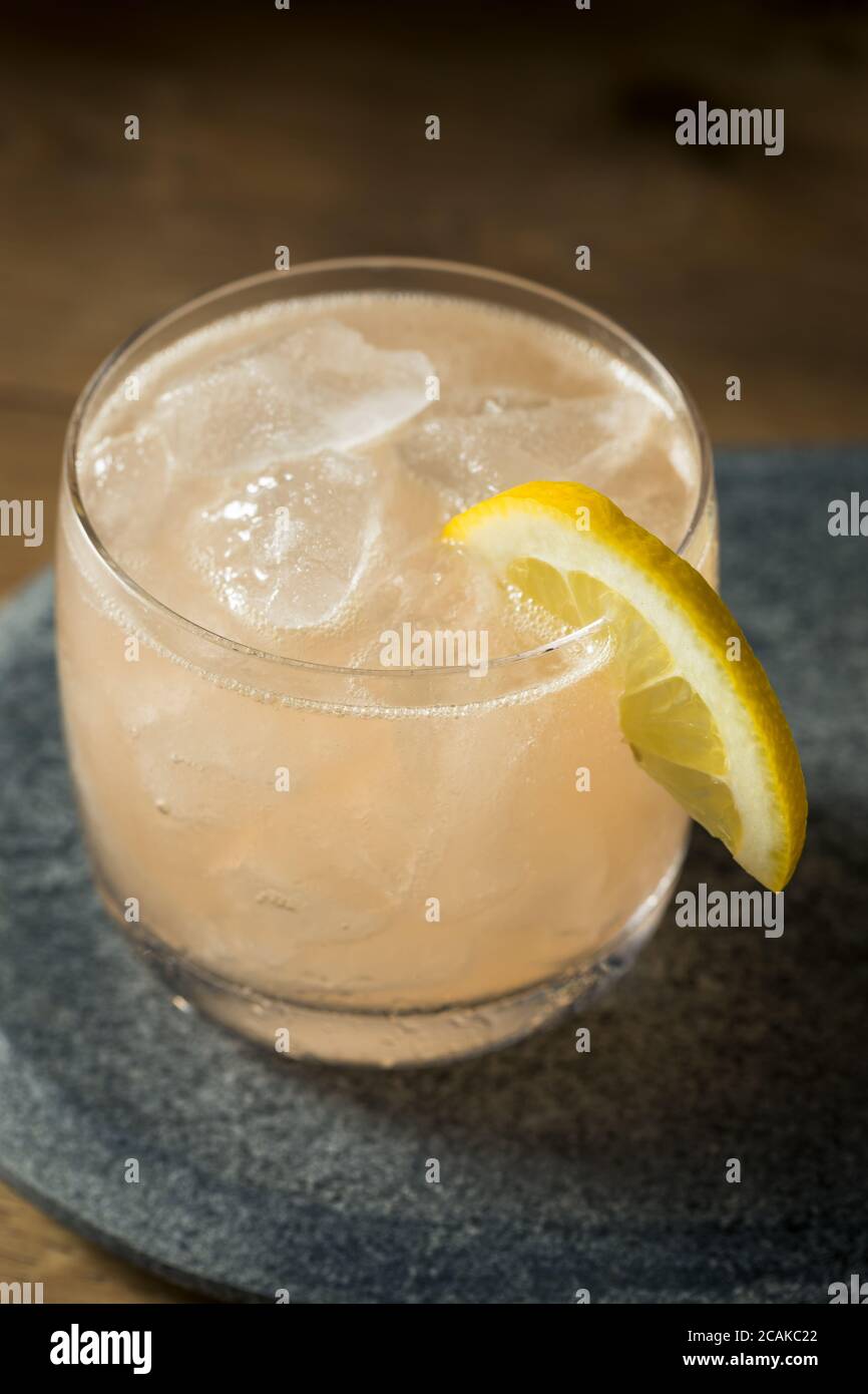 Boozy Sour Gin Fitzgerald Cocktail with a Lemon Garnish Stock Photo - Alamy