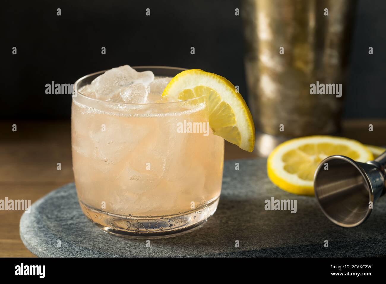 Boozy Sour Gin Fitzgerald Cocktail with a Lemon Garnish Stock Photo - Alamy