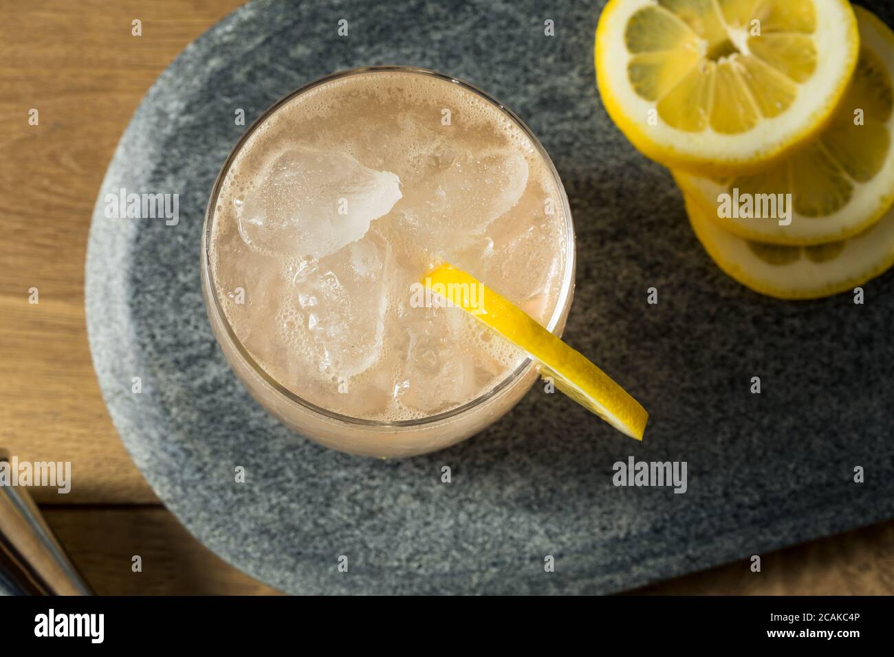 Boozy Sour Gin Fitzgerald Cocktail with a Lemon Garnish Stock Photo - Alamy