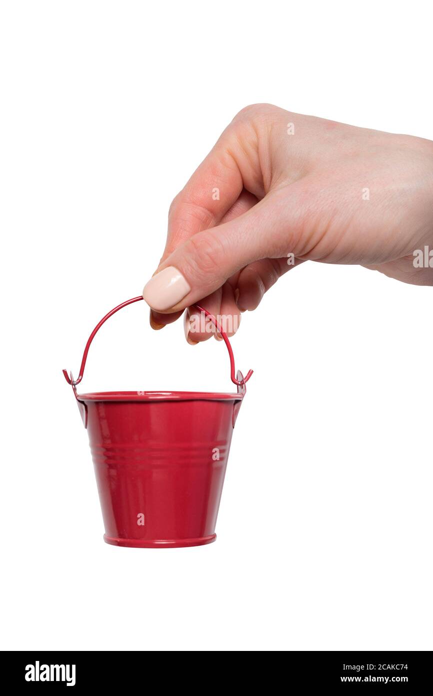 Small red bucket in a female hand. Isolate on white background Stock ...