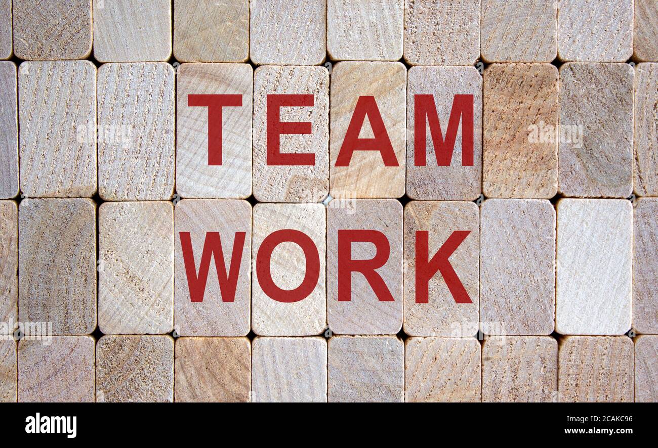 Wooden blocks form the word 'teamwork'. Beautiful wooden background ...