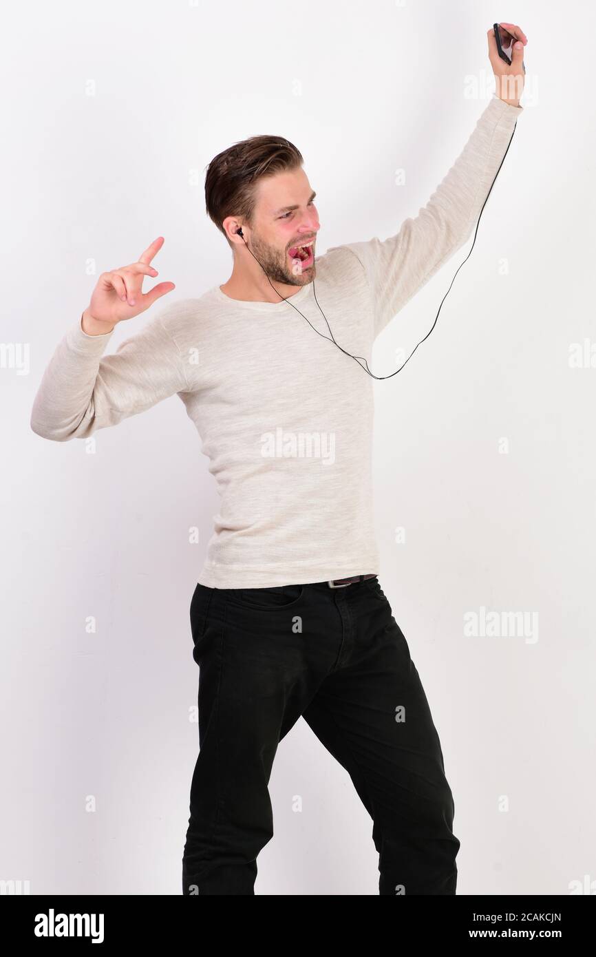 Macho with headphones and cell phone listens to music. Man with stylish ...