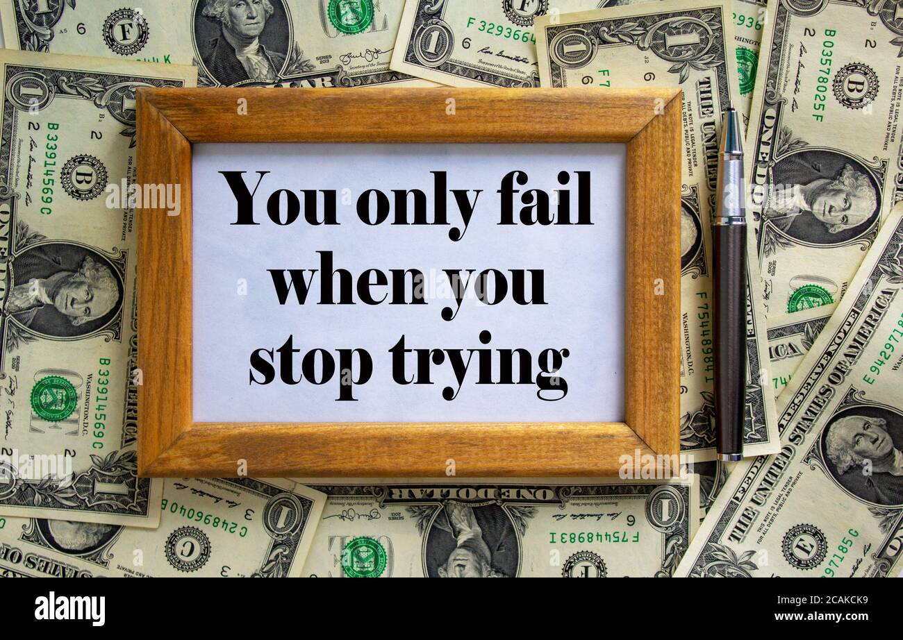 Wooden picture frame with inscription 'you only fail when you stop ...