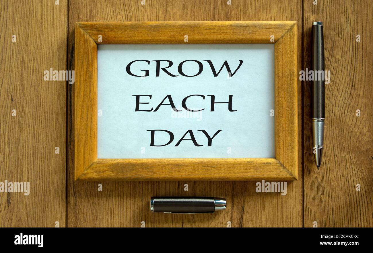 Wooden picture frame with inscription 'grow each day' on beautiful ...