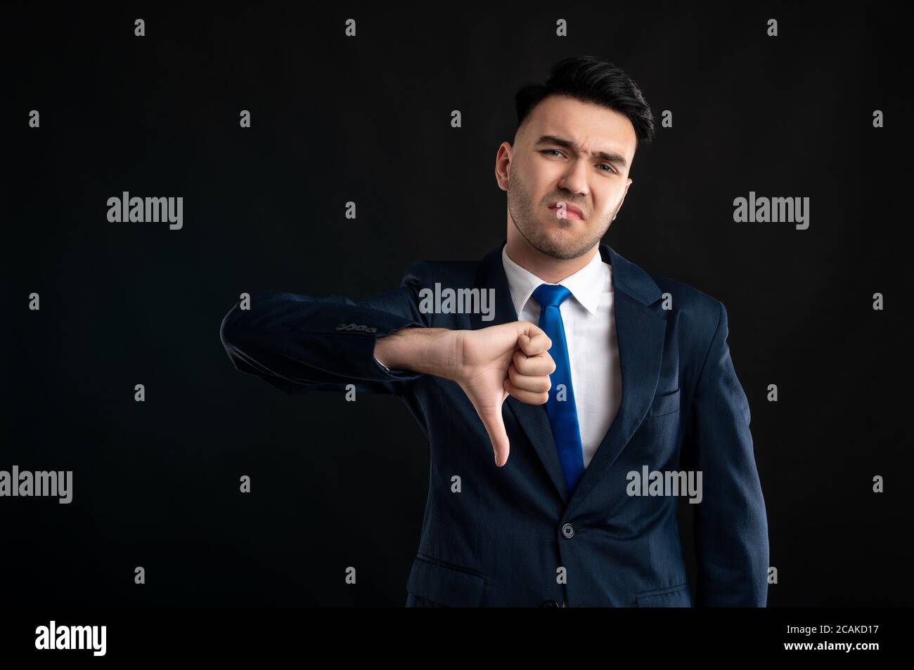 Portrait of business man wearing blue business suit and tie showing ...