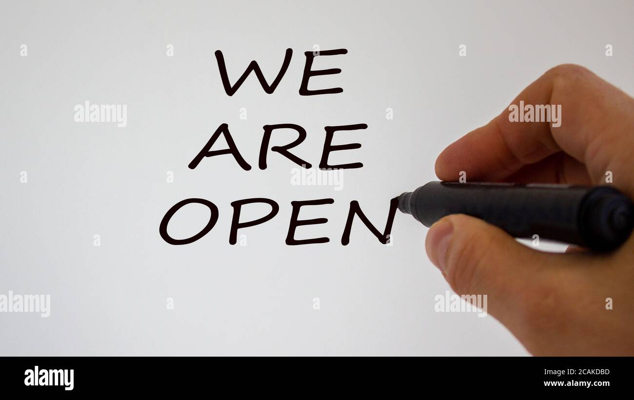 Hand writing 'we are open', isolated on beautiful white background ...
