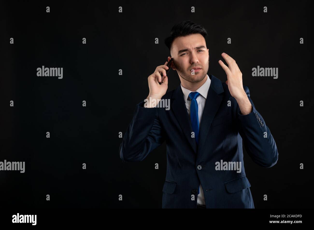 Portrait of angry business man wearing blue business suit and tie ...