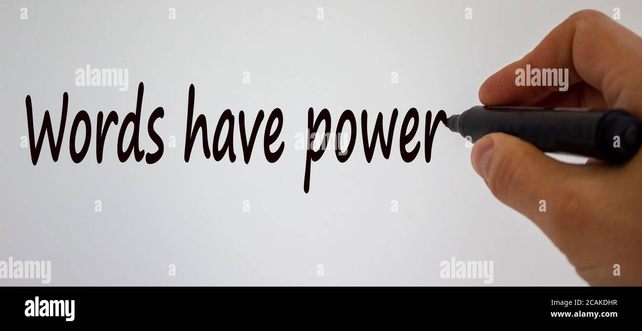 Hand writing 'words have power', isolated on beautiful white background ...