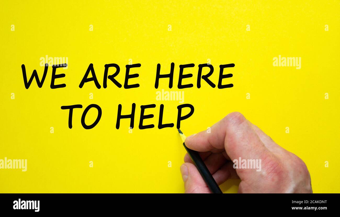 Hand writing 'we are here to help', isolated on yellow background ...