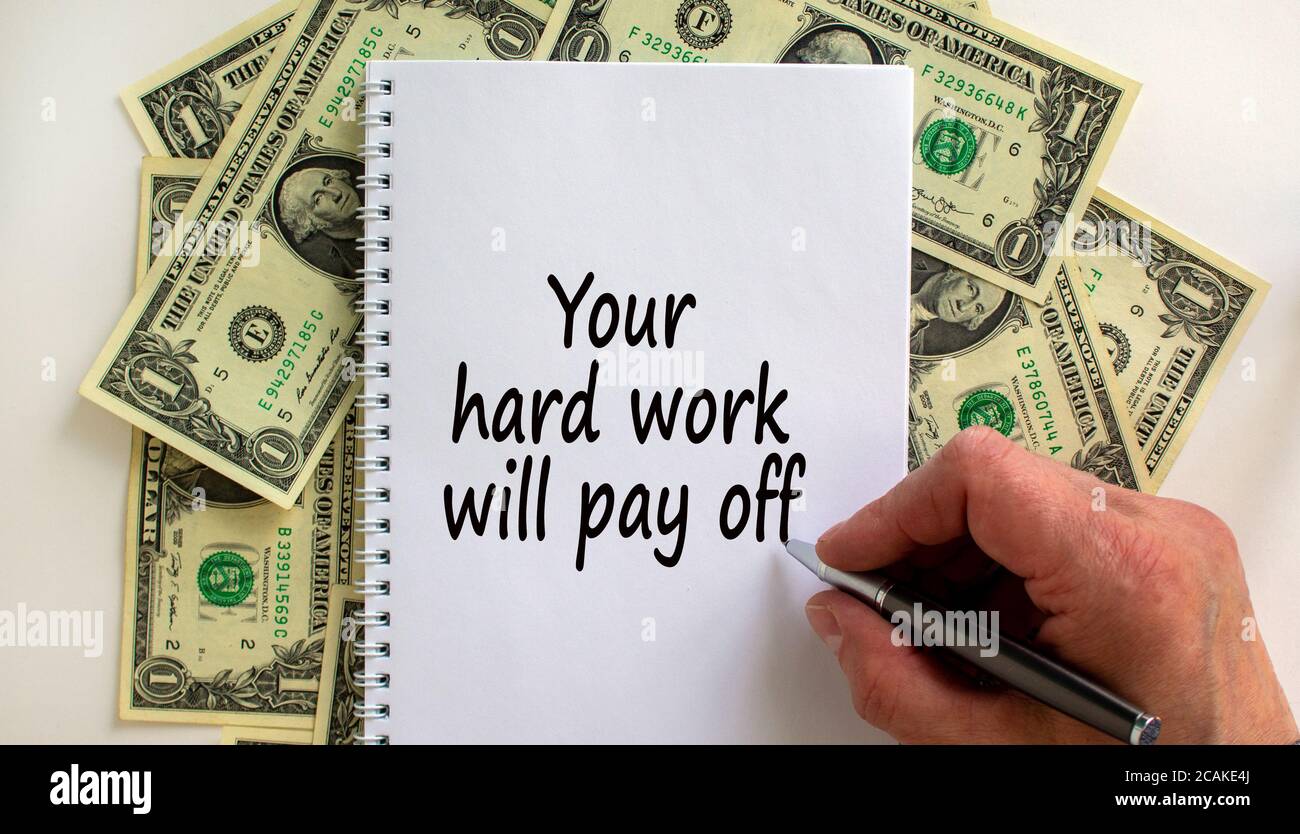 Male hand writing 'your hard work will pay off' on white note, on white ...