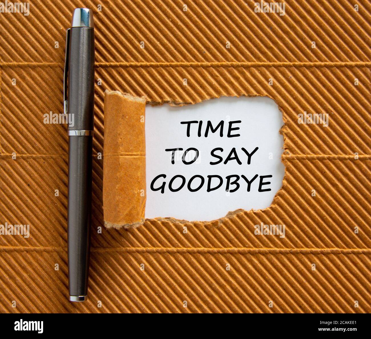 The text 'time to say goodbye' appearing behind torn brown paper ...