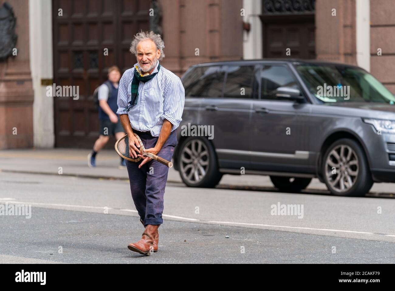 LONDON, ENGLAND - JULY 28, 2020: Eccentric busker dancing and singing ...