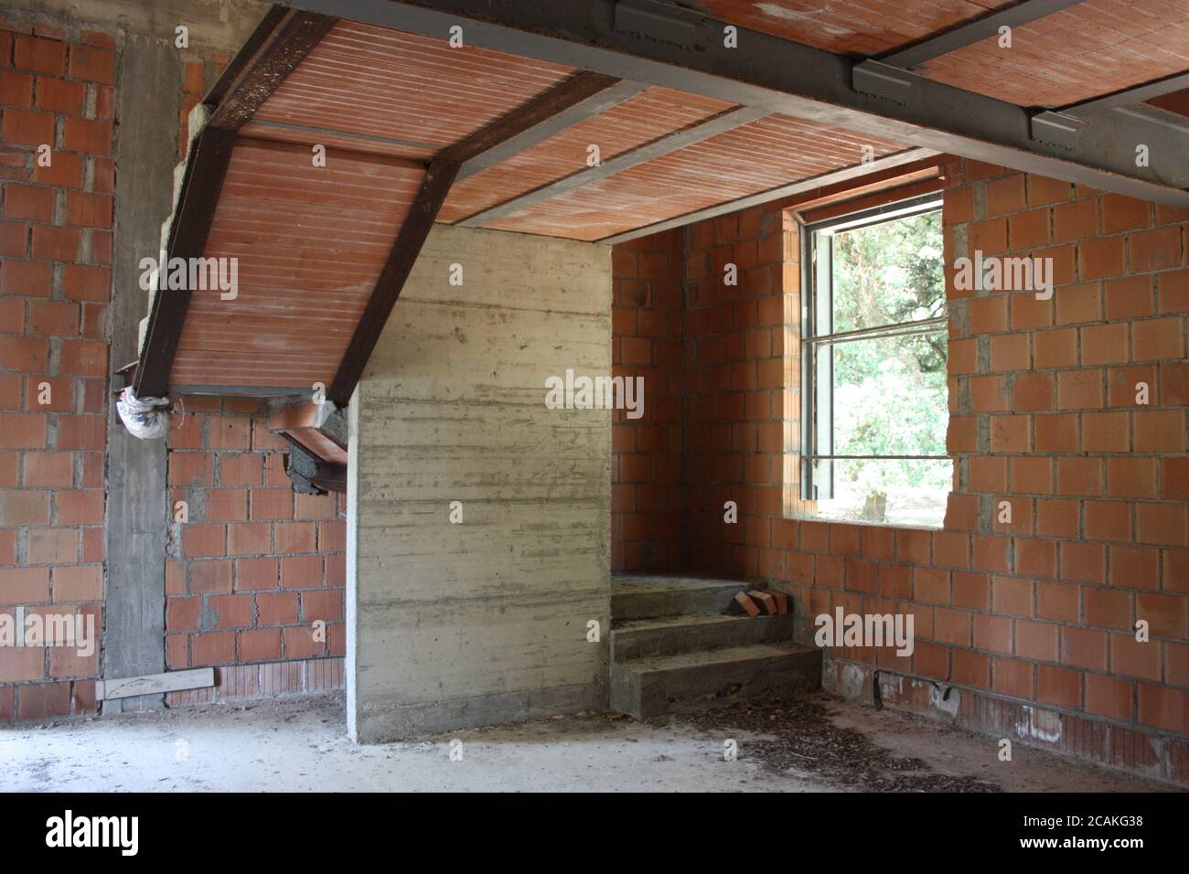 Construction work in progress on a red brick building and beams in a ...