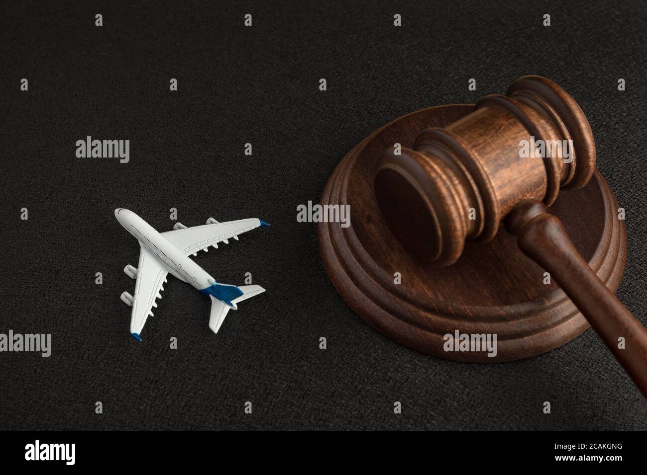 Wooden judges gavel and toy plane. Aviation Law. Lawsuit with the ...