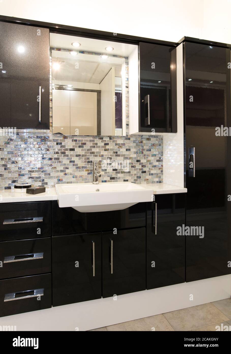 Modern bathroom basin and splash back tiled wall Stock Photo - Alamy