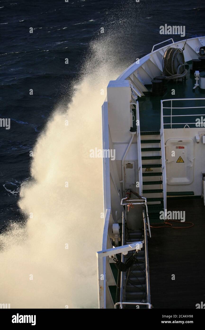 Ship weathering a storm at sunset in the Drake Passage between ...