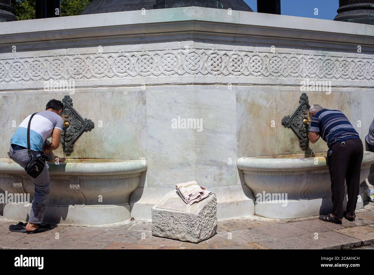 Muslims performing ablution at the German Fountain before prayer ...