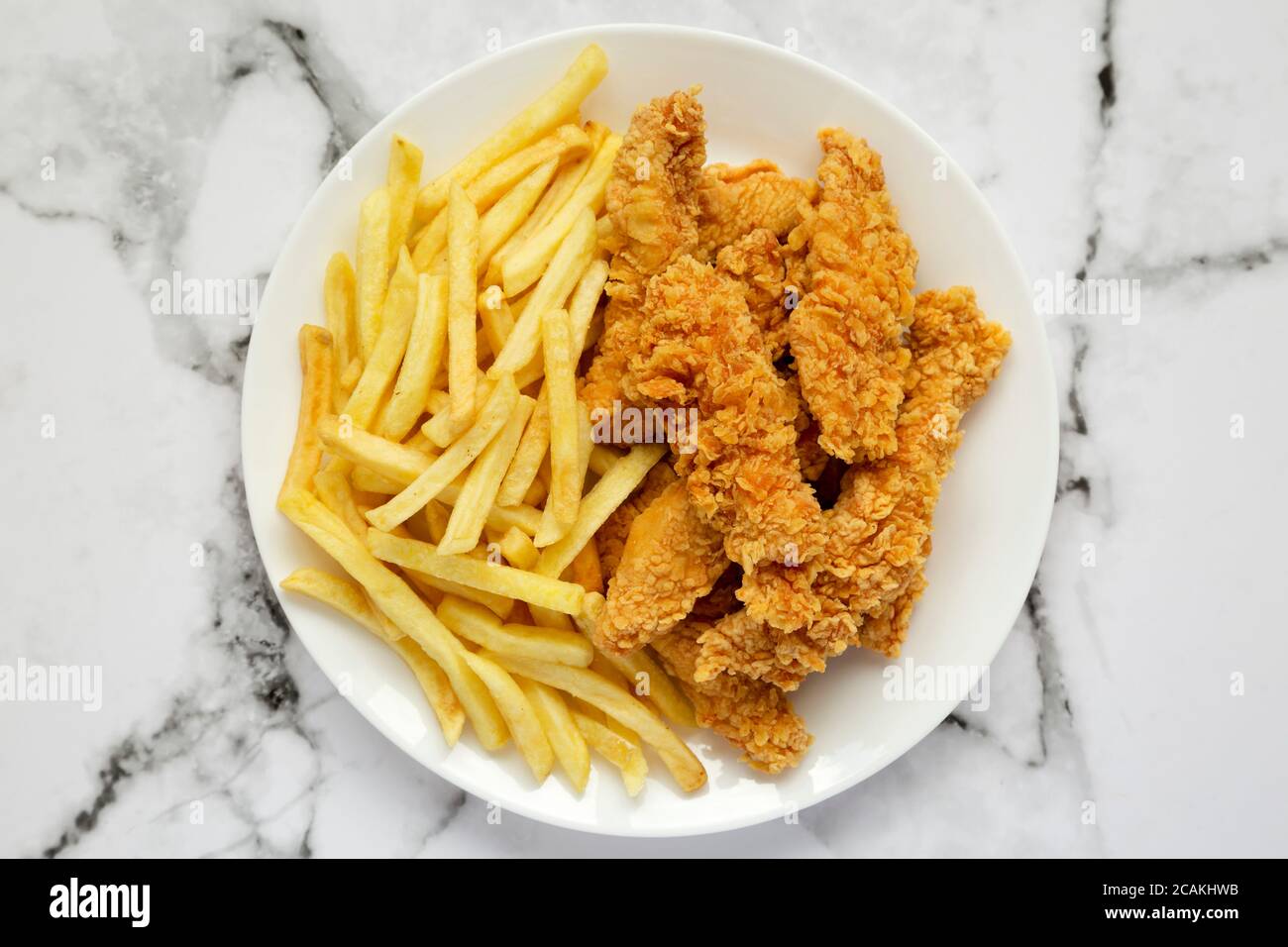 Homemade Crispy Chicken Tenders and French Fries on marble background ...