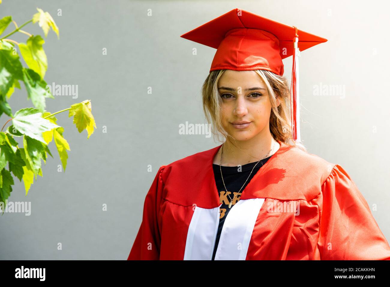 Red Graduation Caps In The Air