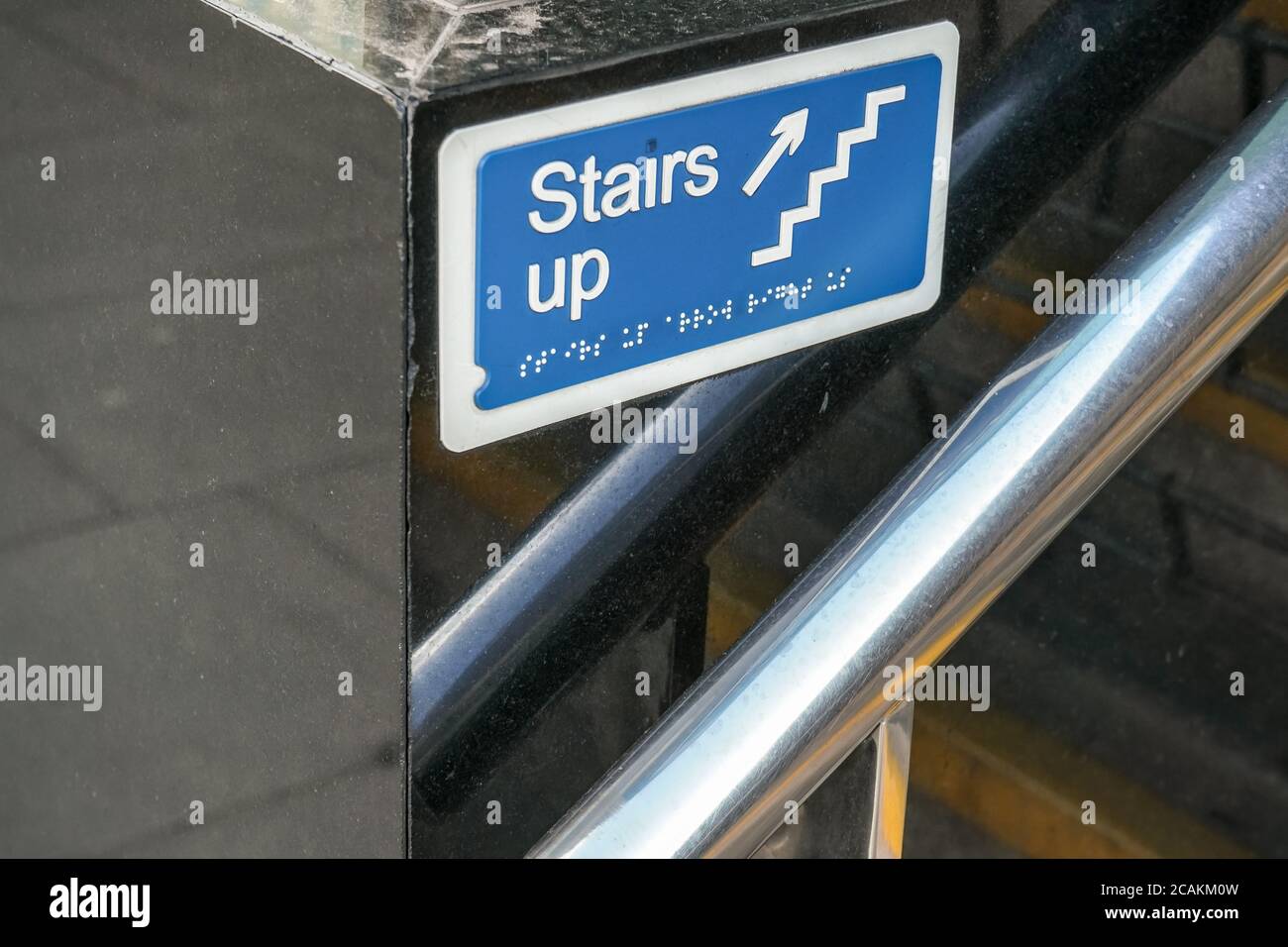 Detail on blue "Stairs up" sign with writing in Braille for blind ...