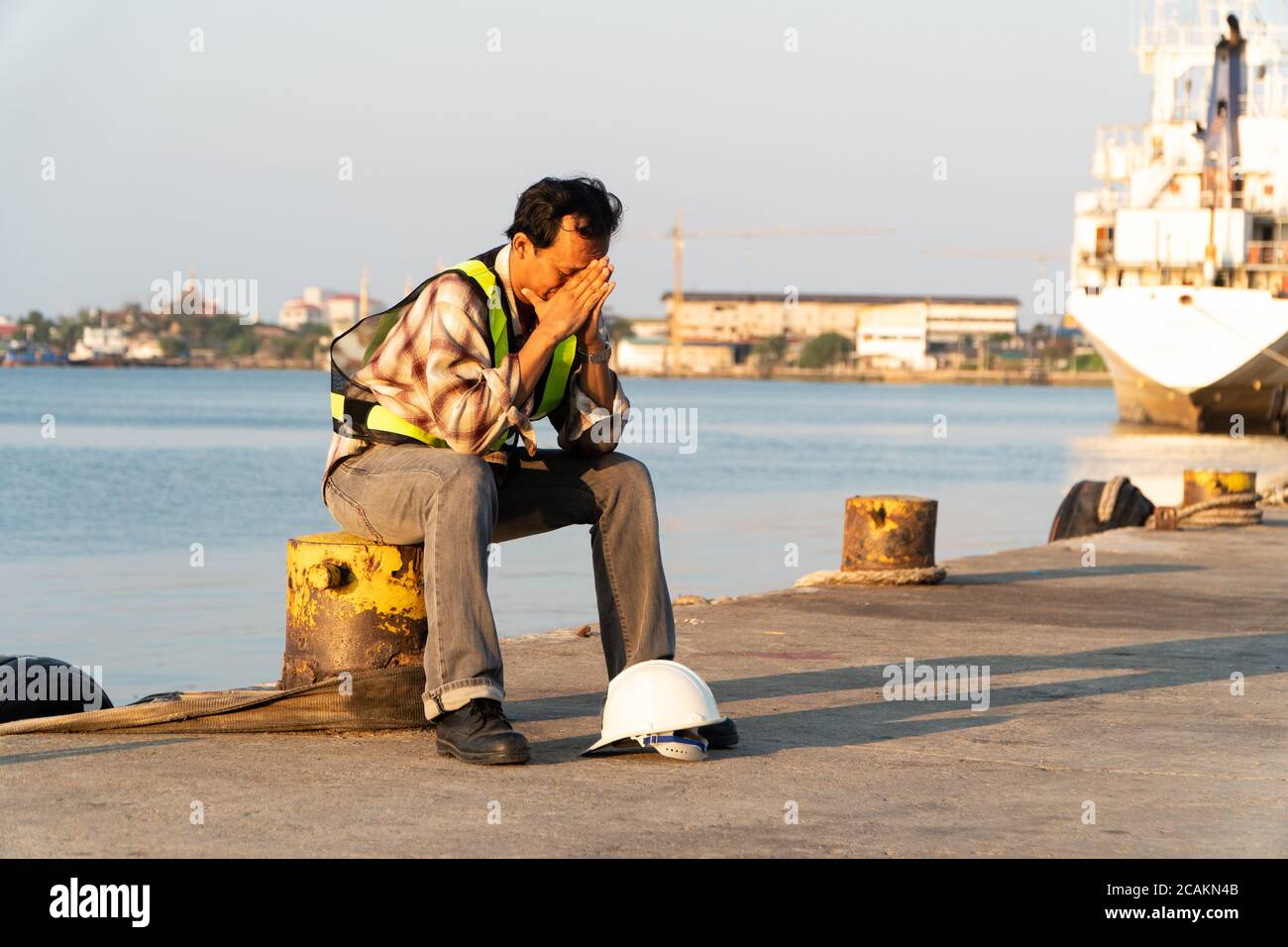 Engineers sitting and wearing a safety helmet. He felt tired ...