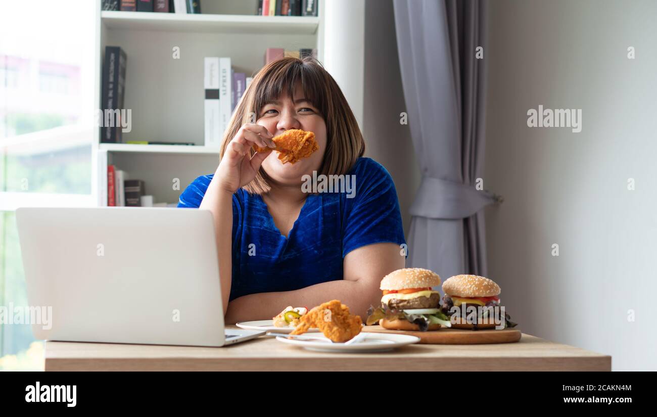 Hungry overweight woman holding Fried chicken after delivery man ...