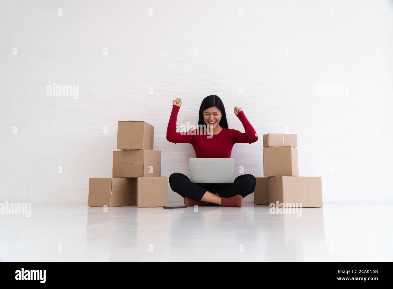 Happy Asian young entrepreneur, Smile for sales success after checking ...