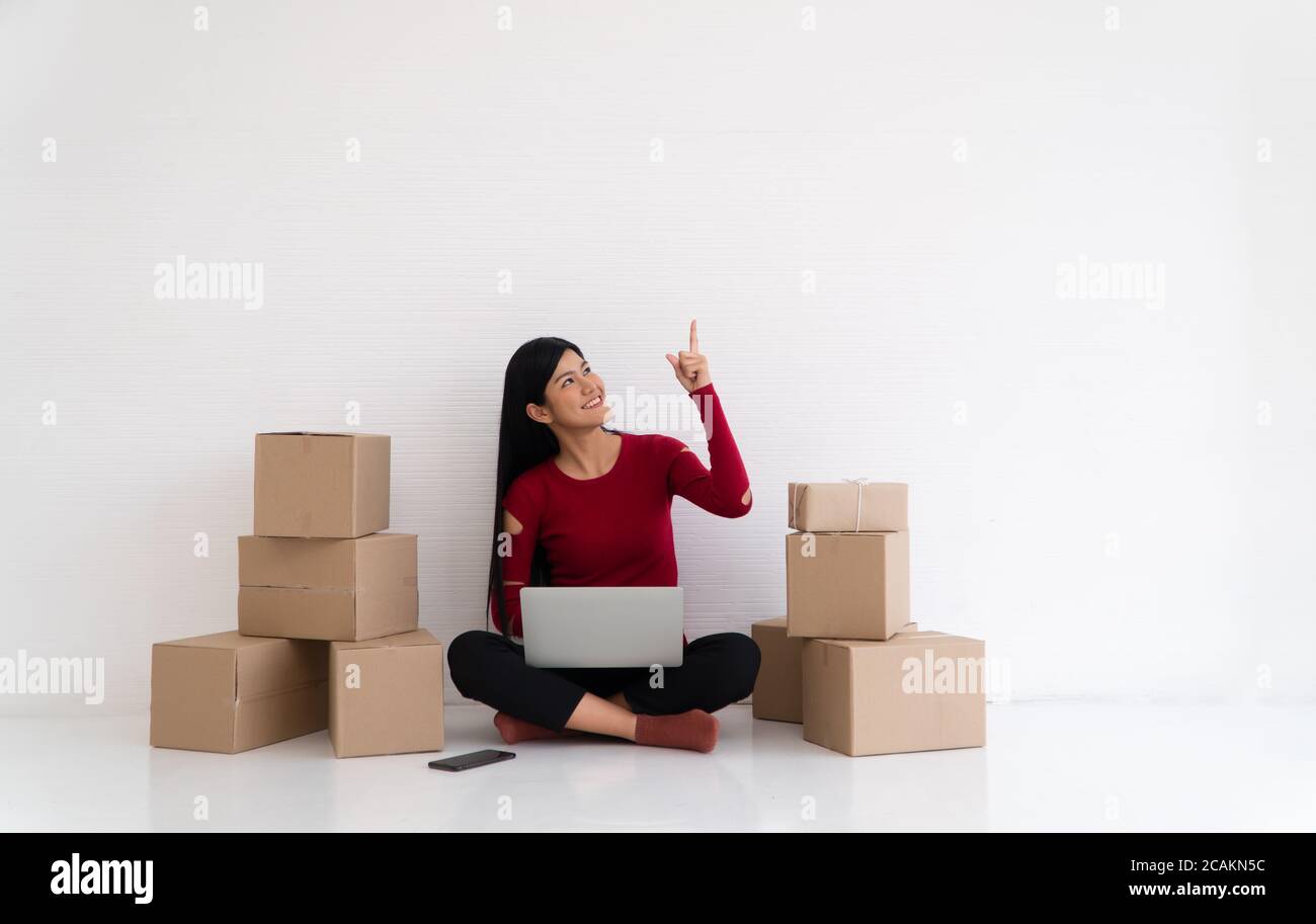 Happy Asian young entrepreneur, Smile for sales success and pointing ...