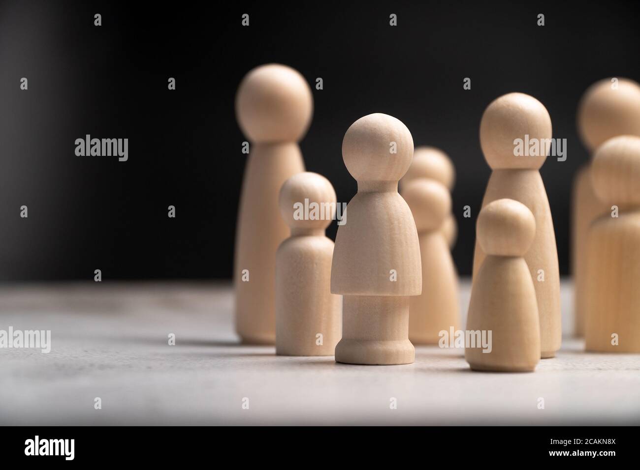 Many wooden human figures, Man and woman standing. Concept of Human ...