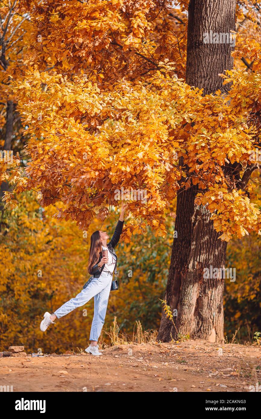 Fall concept - beautiful woman in autumn park under fall foliage Stock ...