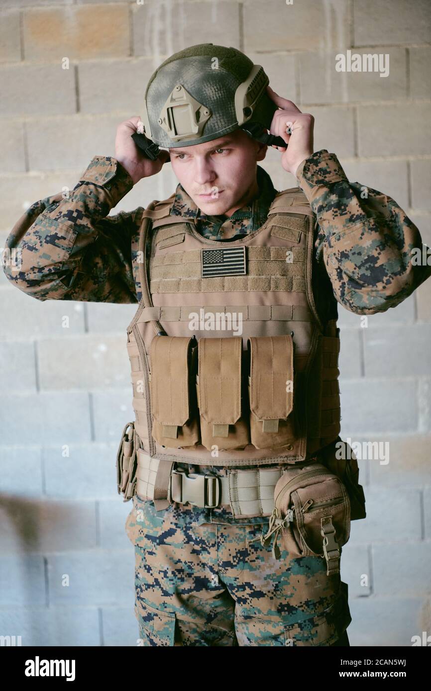 soldier preparing tactical protective and communication gear for action ...