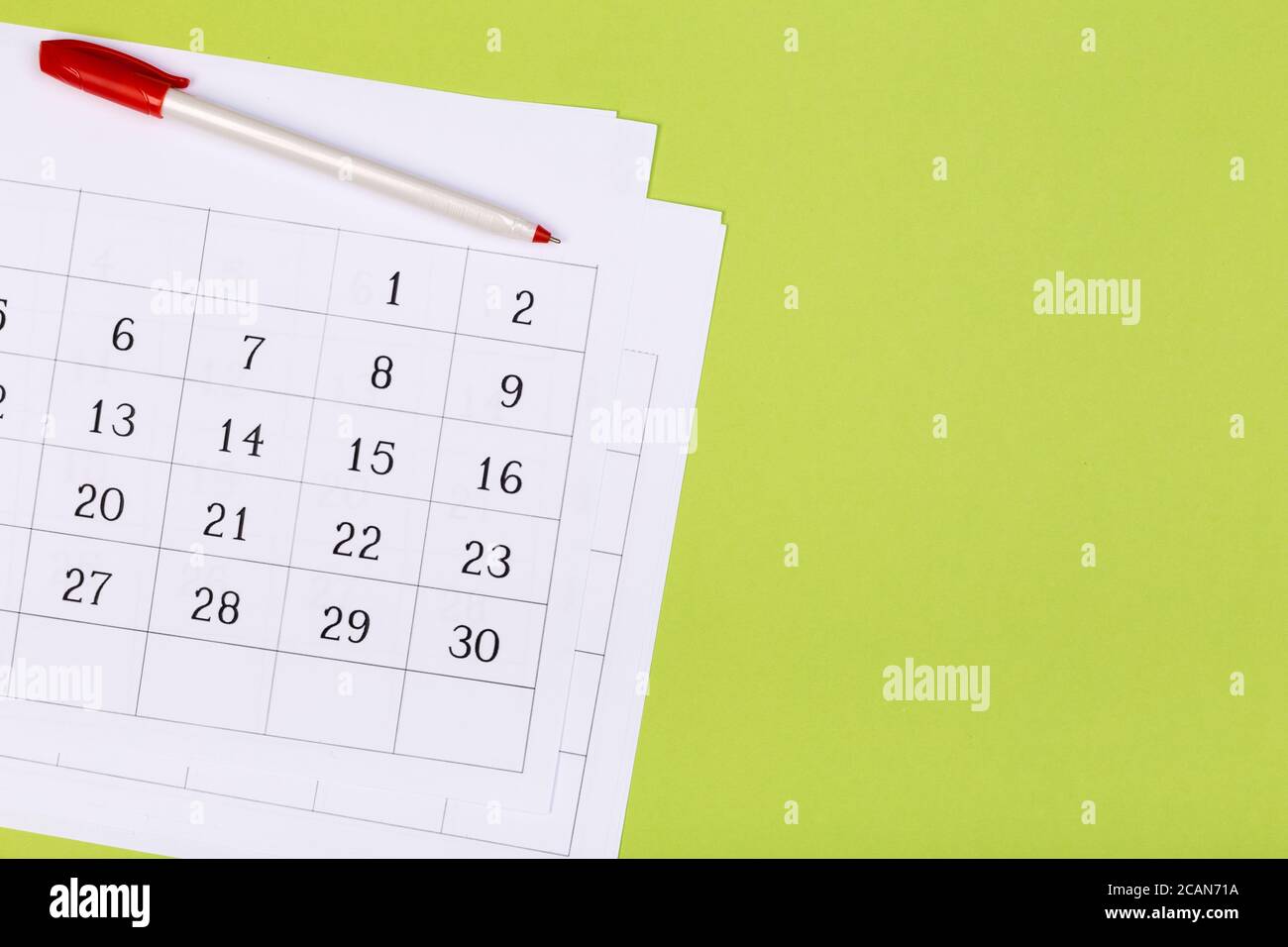Open calendar on the table with green background, planning a business ...