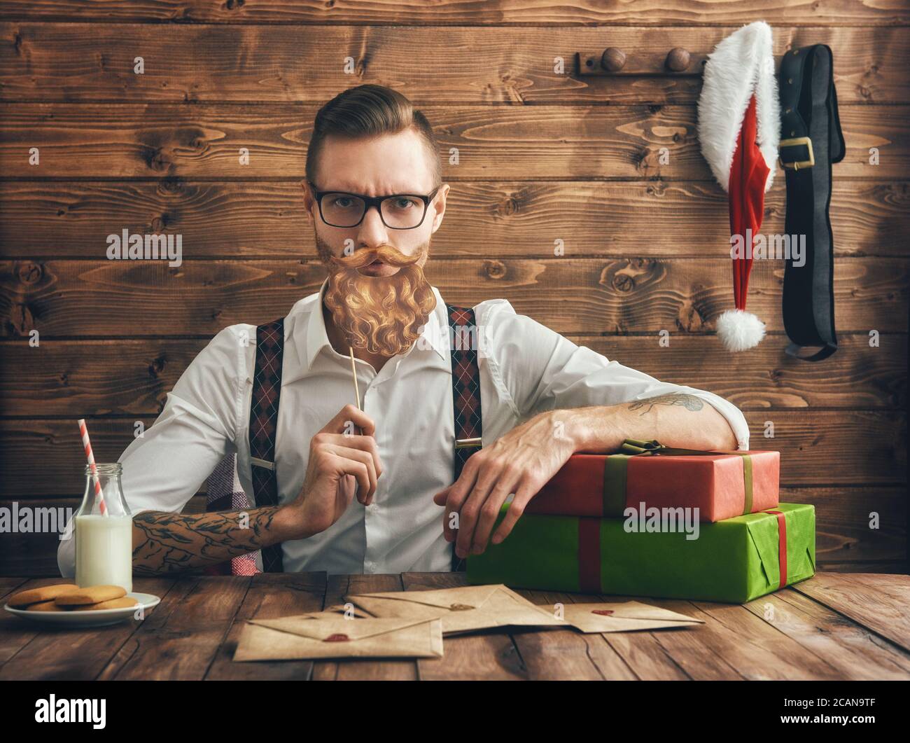 Merry Christmas and Happy Holidays! Handsome man with Santa symbol ...
