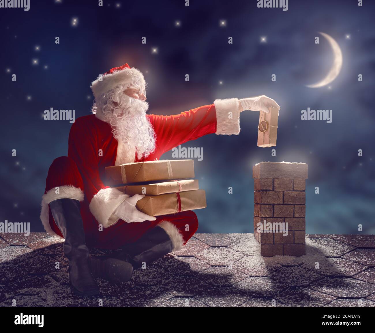 Merry Christmas and happy holidays! Santa Claus sitting on the roof of ...
