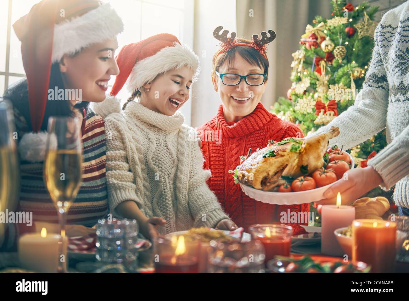 Merry Christmas! Happy family are having dinner at home. Celebration holiday and togetherness ...