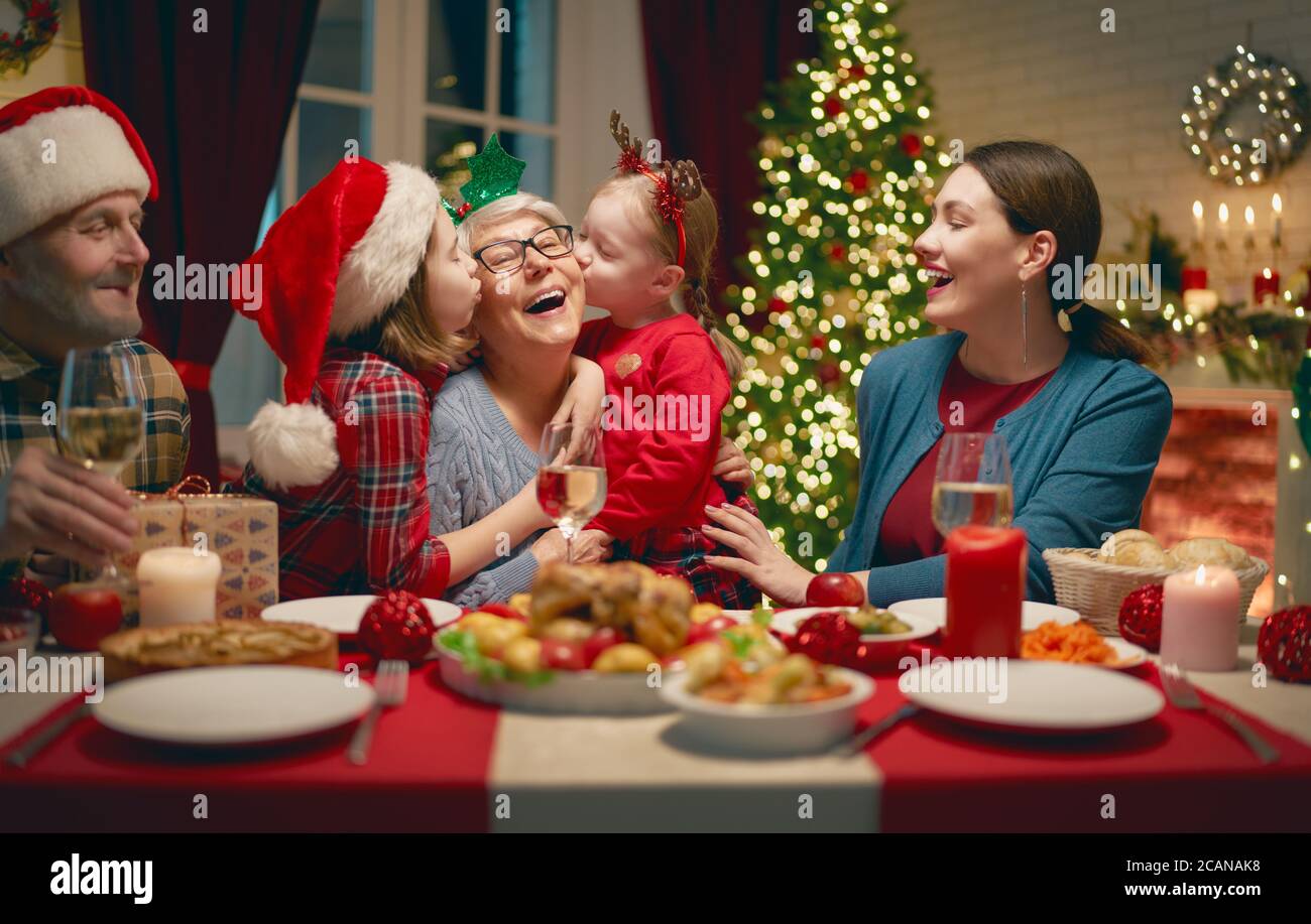 Merry Christmas! Happy family are having dinner at home. Celebration holiday and togetherness ...